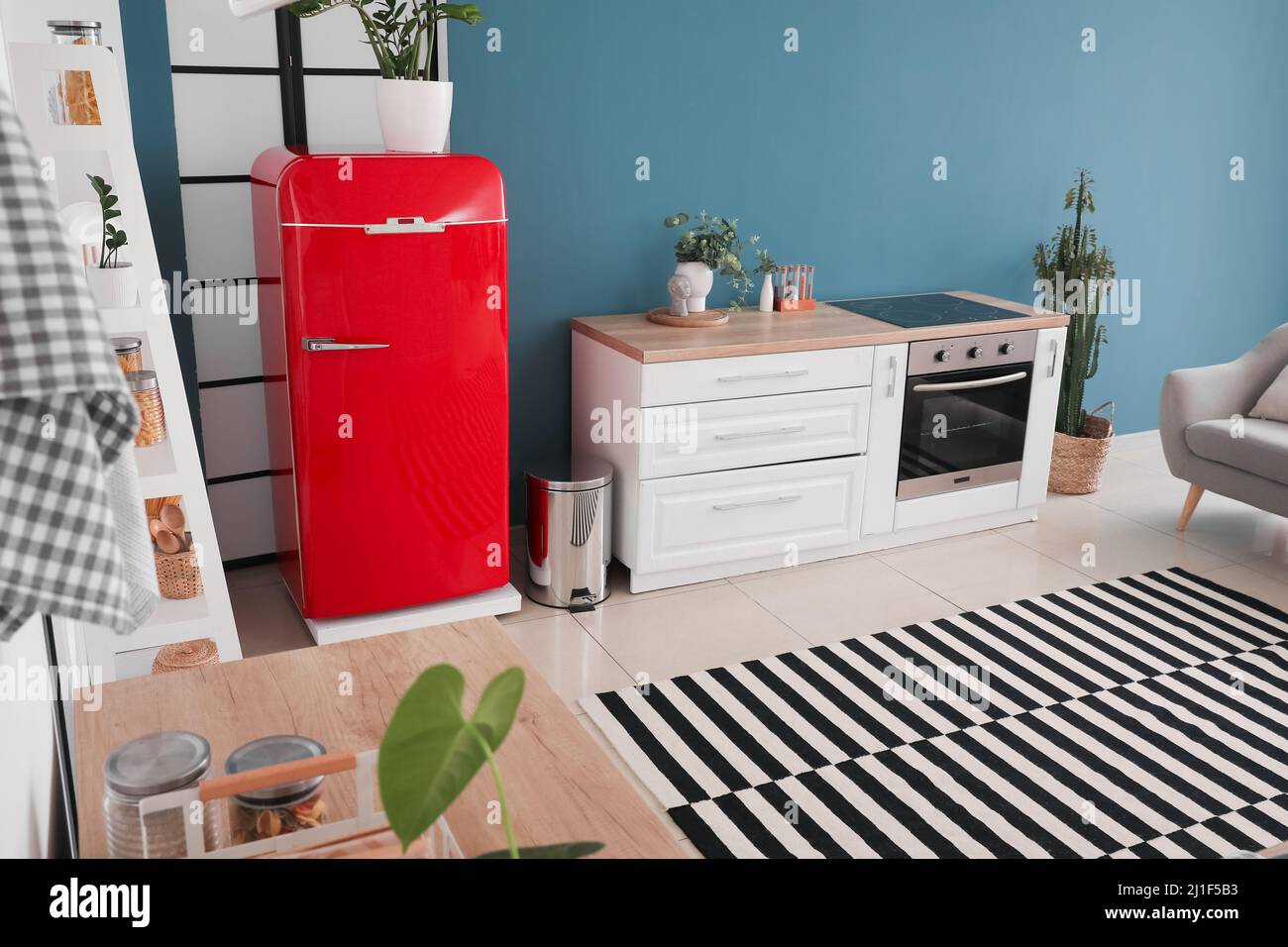 Red vintage fridge in interior of kitchen Stock Photo - Alamy