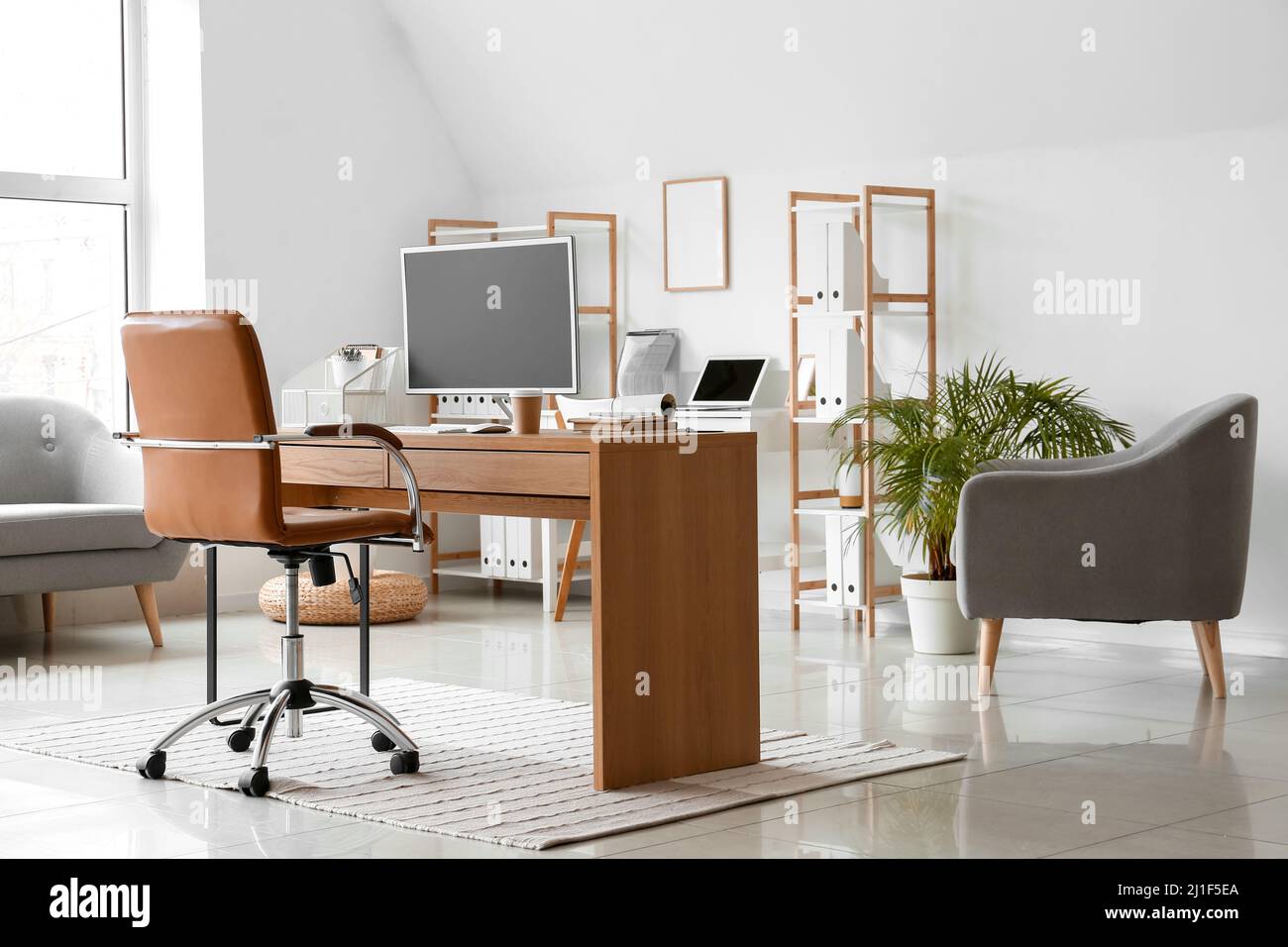 Workplace with modern computer in light office interior Stock Photo - Alamy