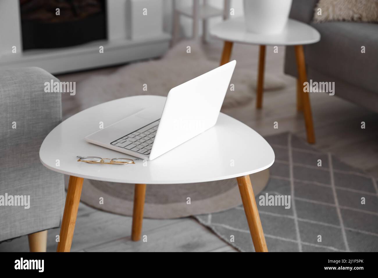 Modern laptop on white table in room Stock Photo - Alamy
