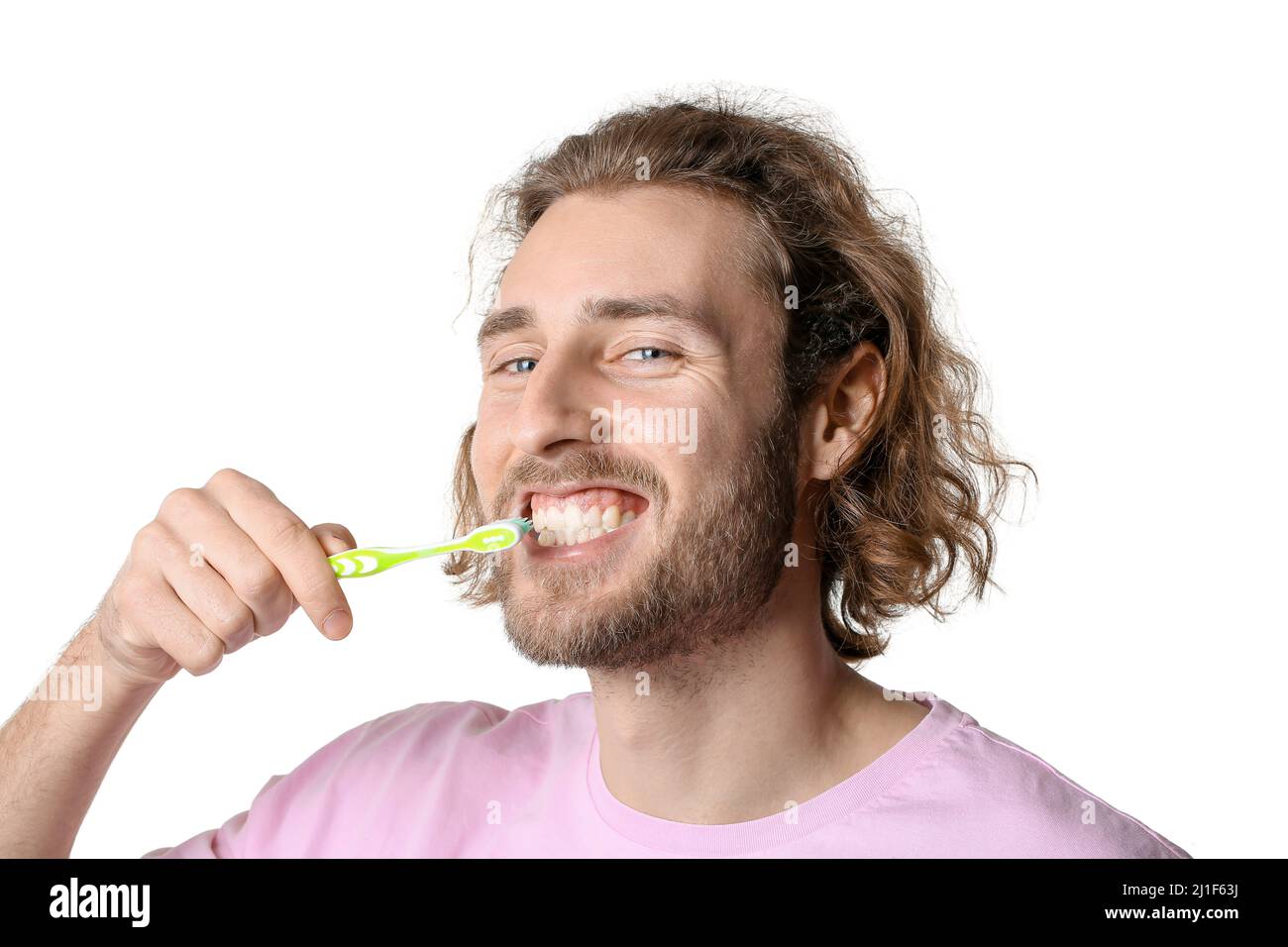 Handsome young man brushing teeth on white background Stock Photo - Alamy