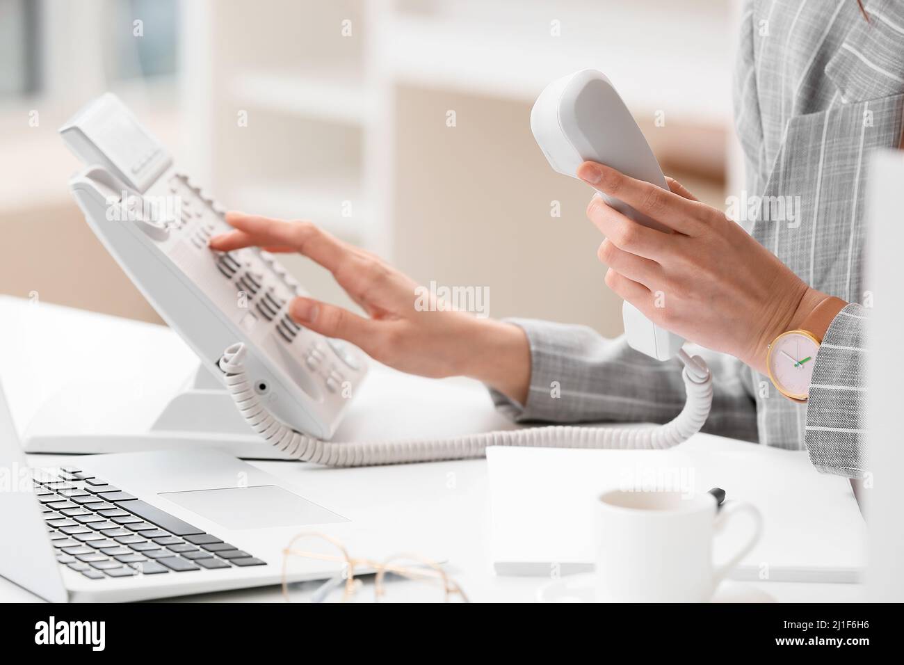 Young secretary dialing phone number in office, closeup Stock Photo - Alamy