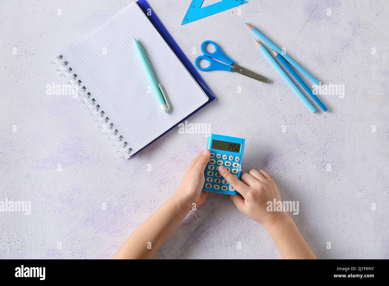 Child using calculator on light background Stock Photo - Alamy