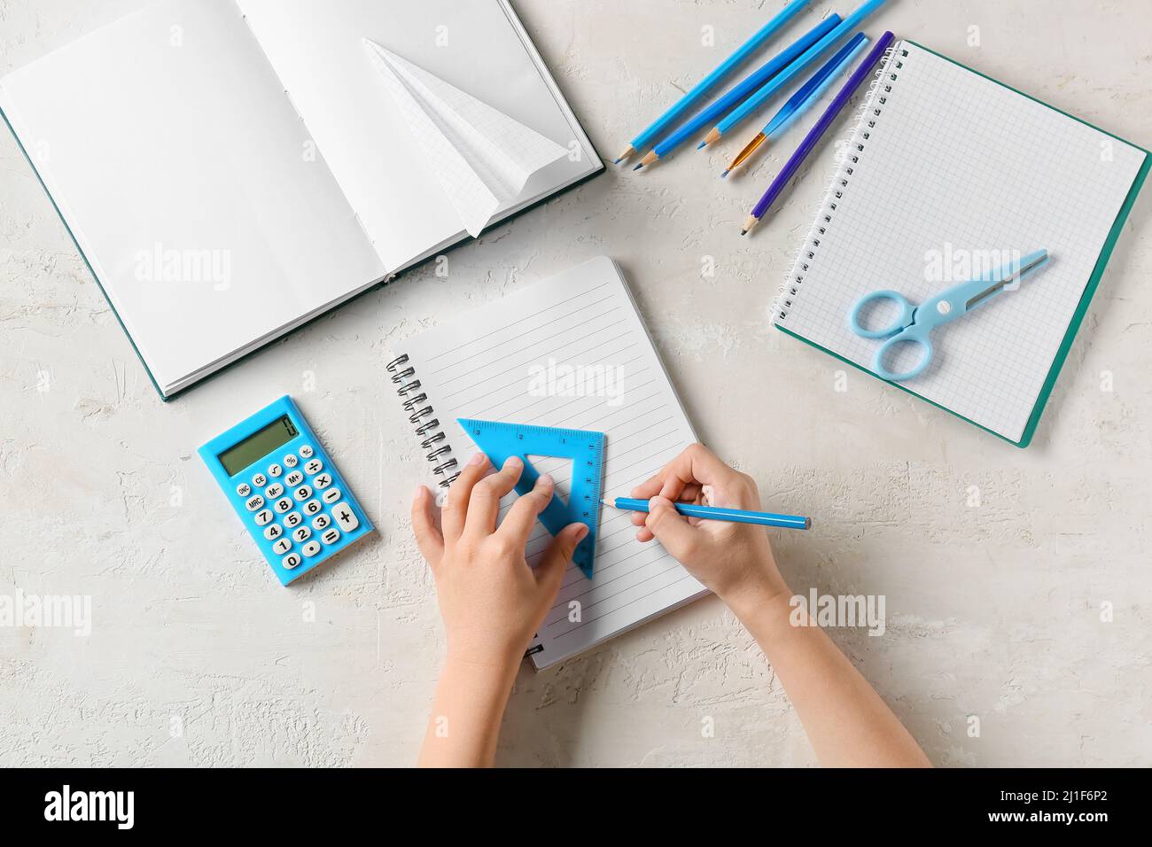 Child drawing with ruler and pencil on light background Stock Photo - Alamy