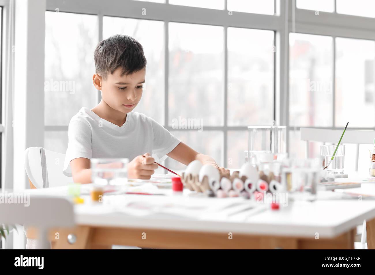 Cute boy painting during master-class in art on Easter eve Stock Photo ...
