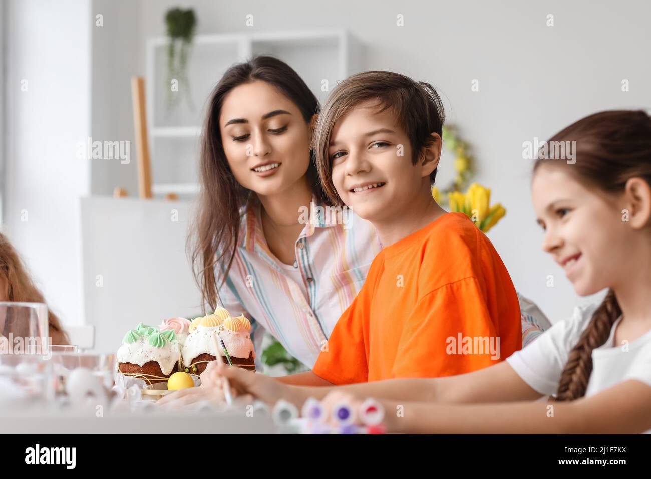 Cute children painting during master-class in art on Easter eve Stock ...