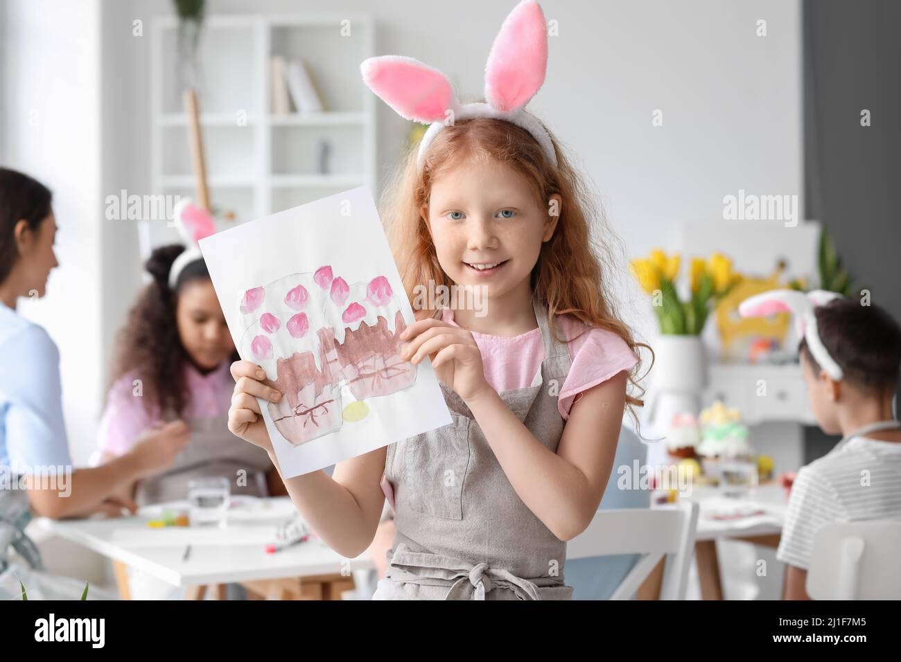 Cute girl with picture of Easter cakes painted during master-class in ...