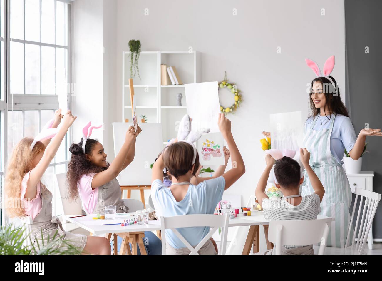 Cute children painting during master-class in art on Easter eve Stock ...