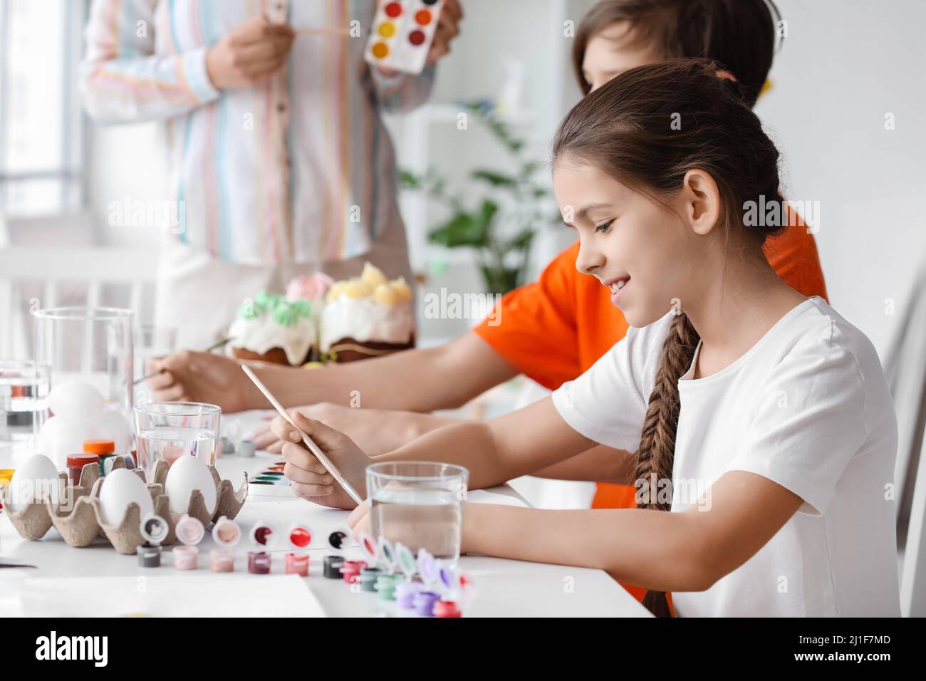 Cute children painting during master-class in art on Easter eve Stock ...