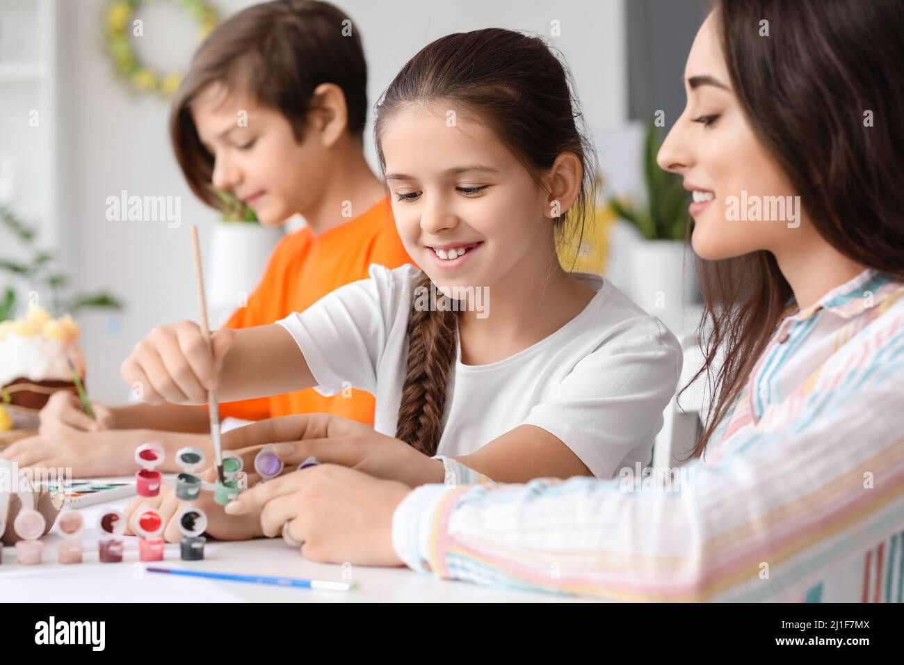 Cute children painting during master-class in art on Easter eve Stock ...
