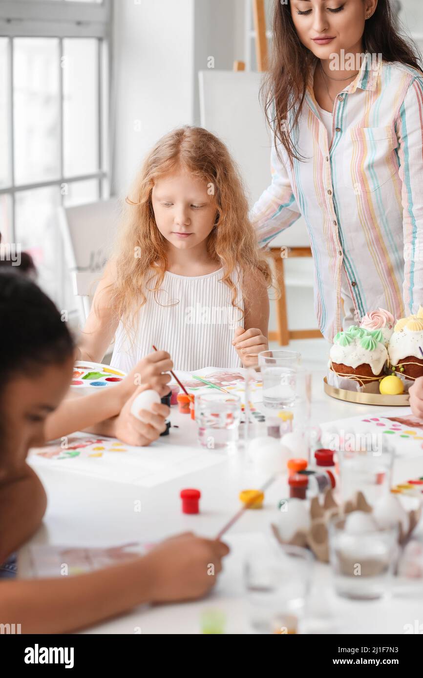 Cute children painting during master-class in art on Easter eve Stock ...