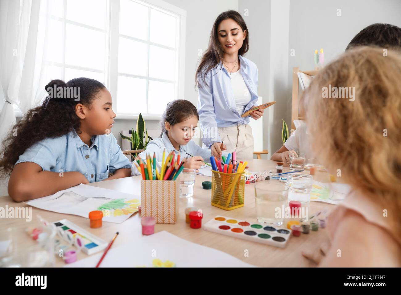 Cute children painting during master-class in art Stock Photo - Alamy