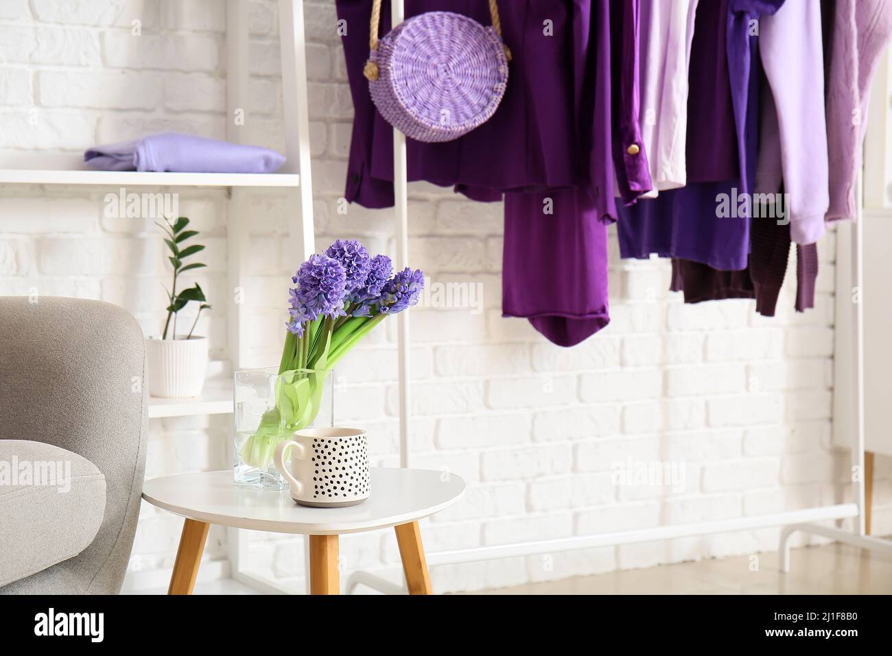 Vase with flowers and cup on table in dressing room Stock Photo - Alamy