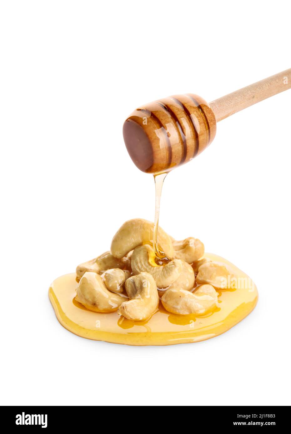 Pouring honey onto cashew nuts on white background Stock Photo - Alamy