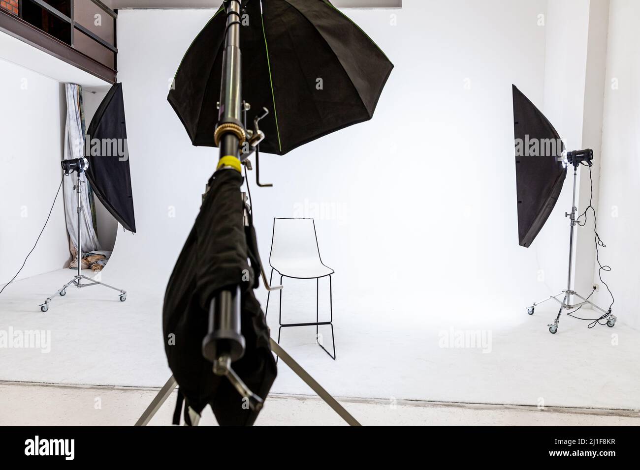 Empty photo studio with lighting equipment. Photographer workplace ...