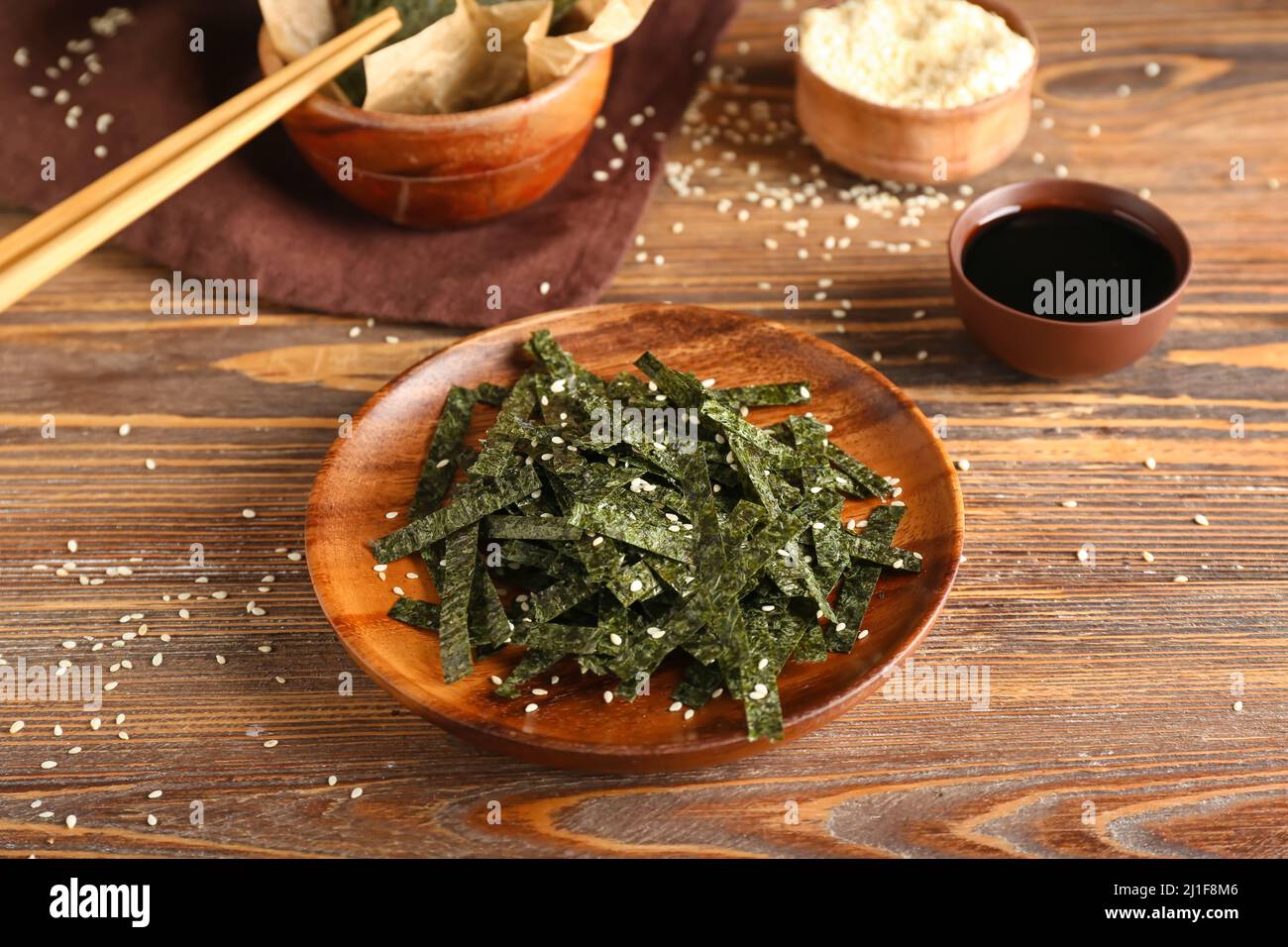 Plate of chopped seaweed sheets with sesame on wooden background Stock ...