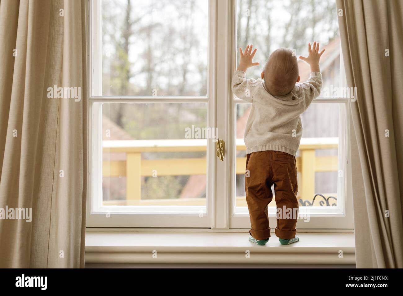 Infant of window hi-res stock photography and images - Alamy
