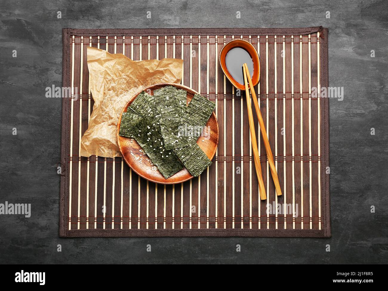 Plate of tasty seaweed sheets on black background Stock Photo - Alamy