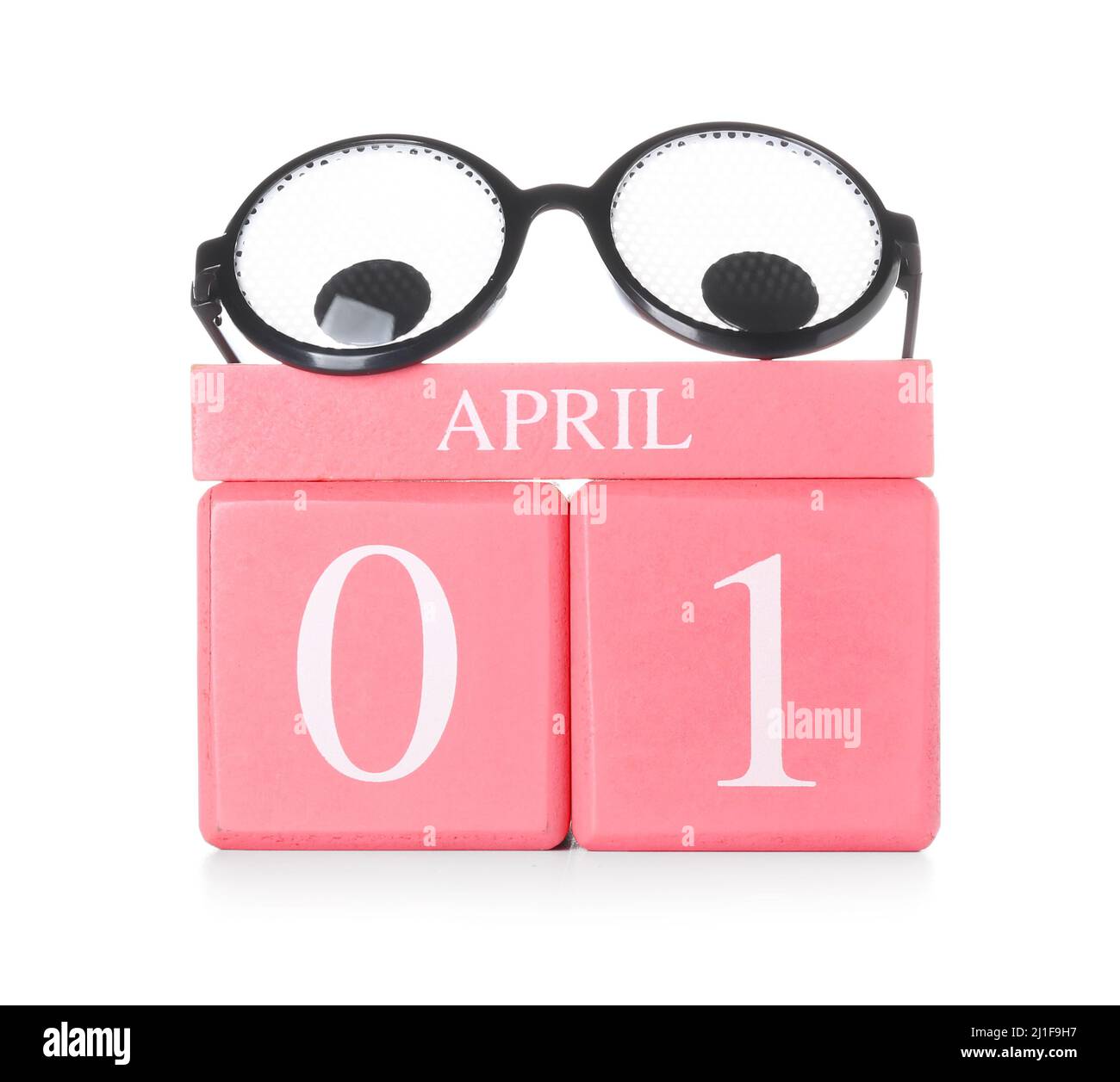 Calendar with date of April Fool's Day and funny eyeglasses on white ...