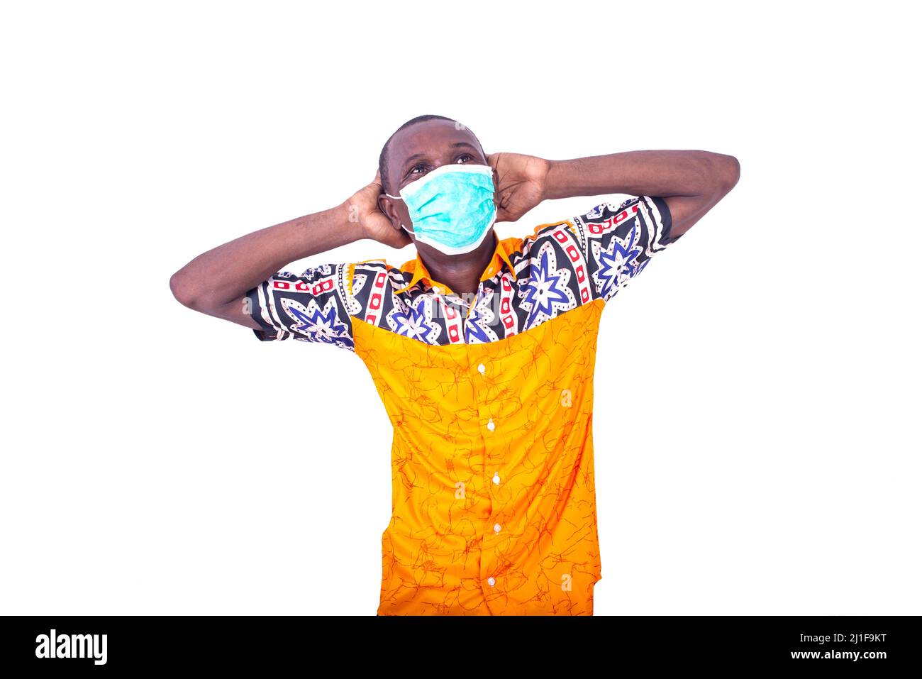 handsome panicked young man, wearing medical mask, standing in shirt ...