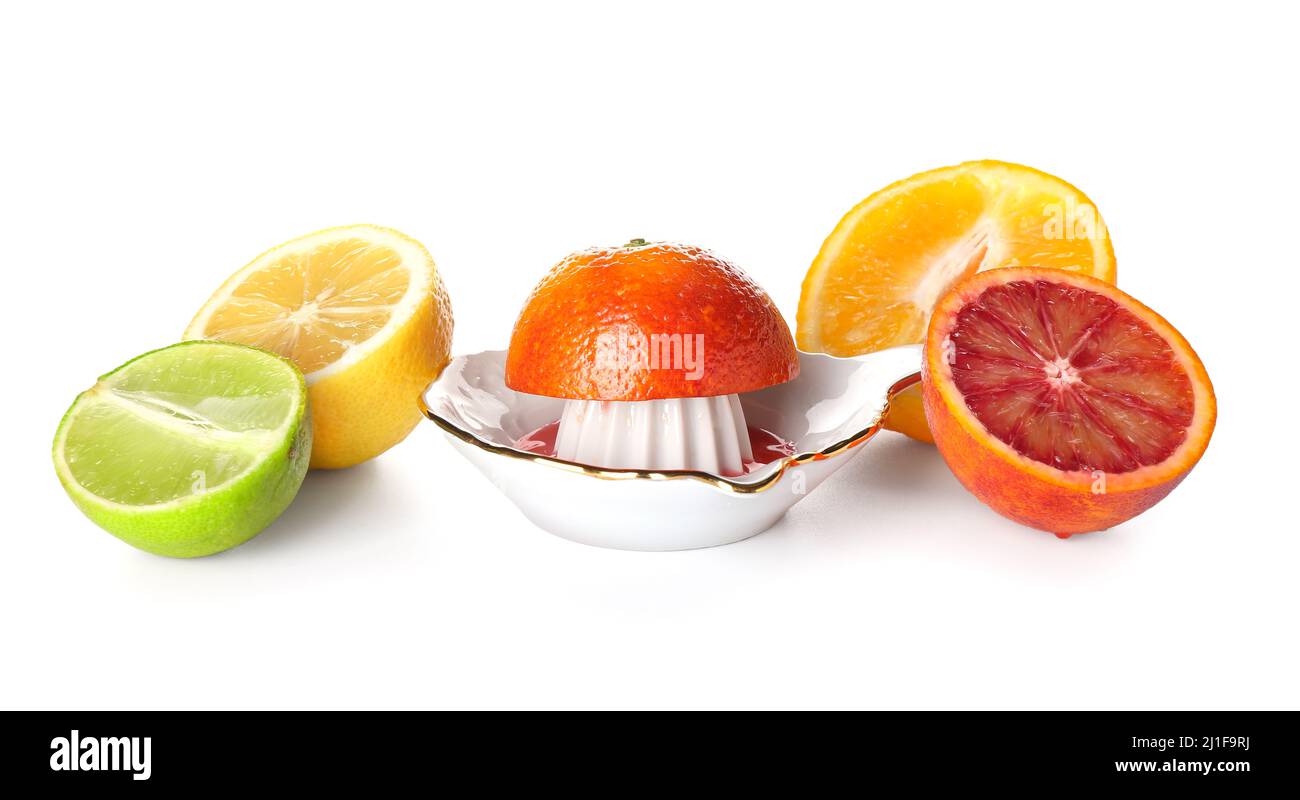 Ceramic juicer and citrus fruits on white background Stock Photo - Alamy