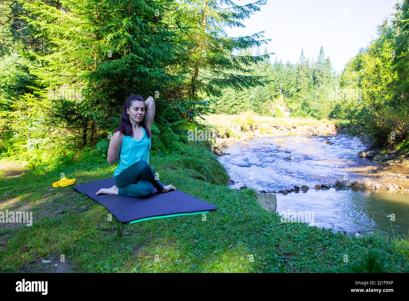 Woman yoga mountains river beach hi-res stock photography and images ...