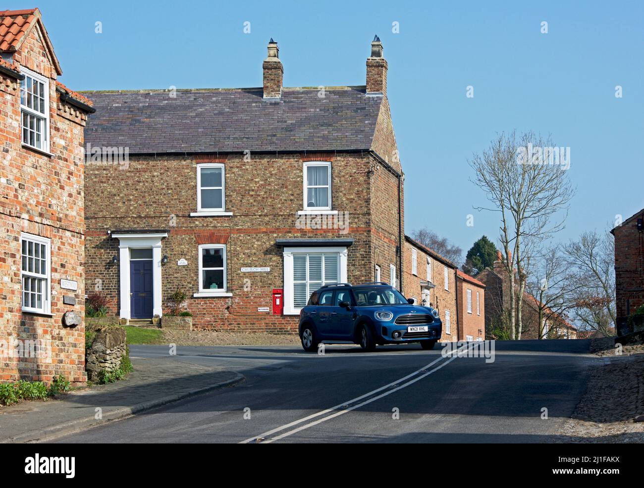 Car at road junction in the village of Crayke, North Yorkshire, England ...
