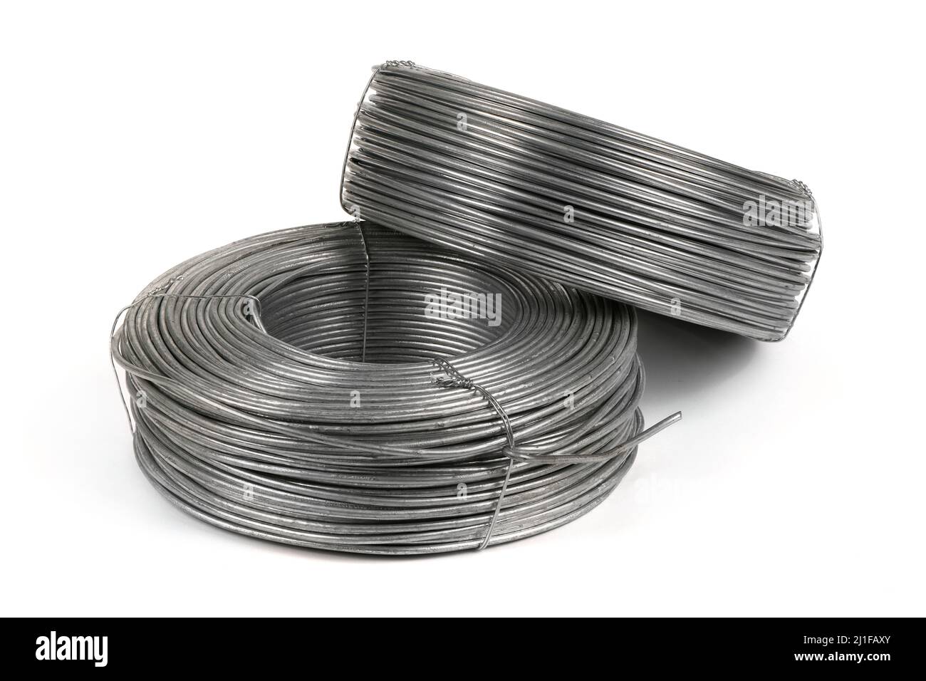 Two coils of galvanized wires lying on white background. High ...
