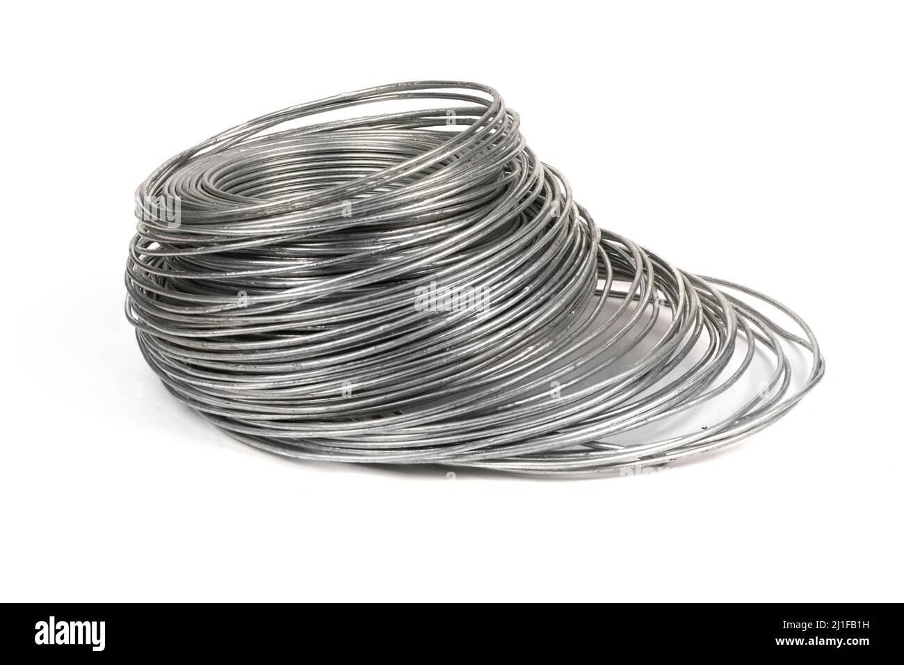 Coil of galvanized wires lying on white background. High resolution ...