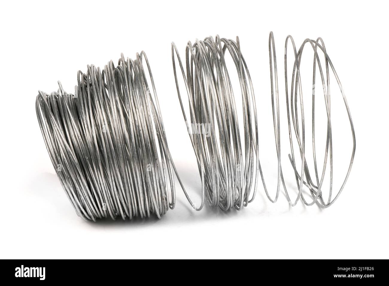 Coil of galvanized wires lying on white background. High resolution ...