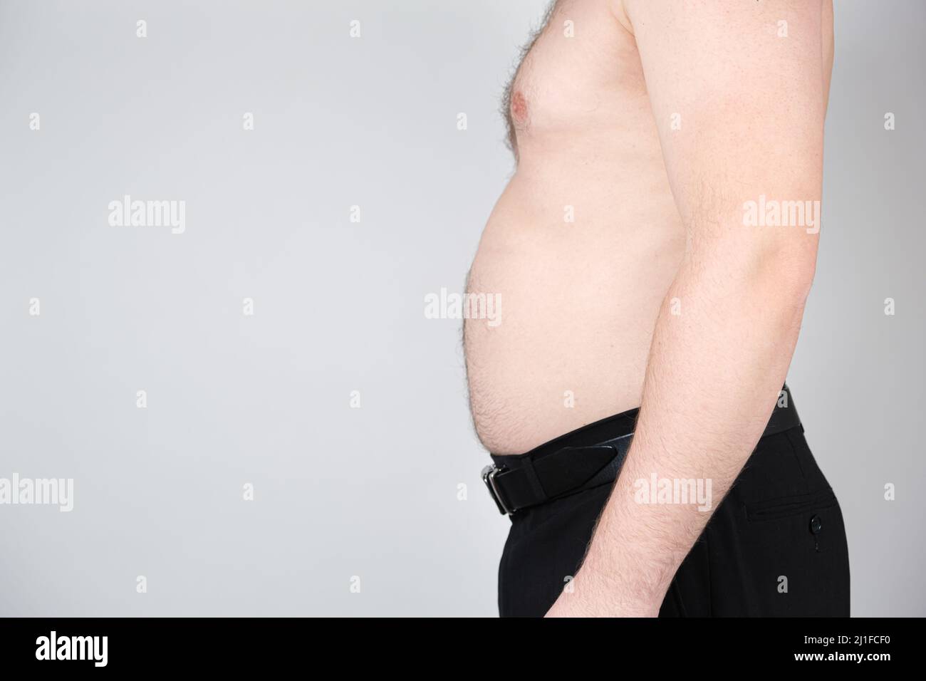 A man with a thick belly close-up. Obesity in men, bloating Stock Photo ...