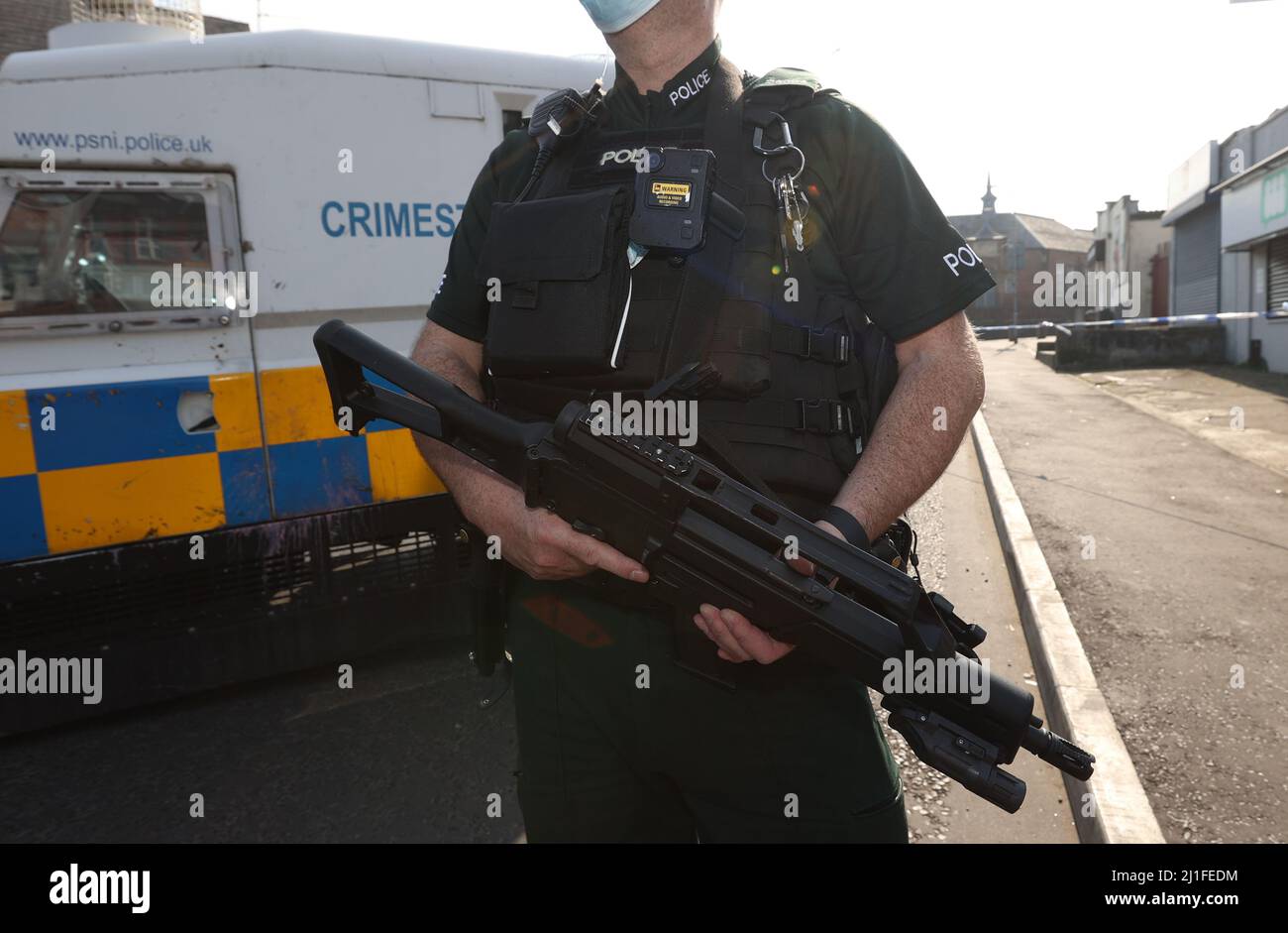 An armed PSNI officer holds a submachine gun at a police cordon as ...
