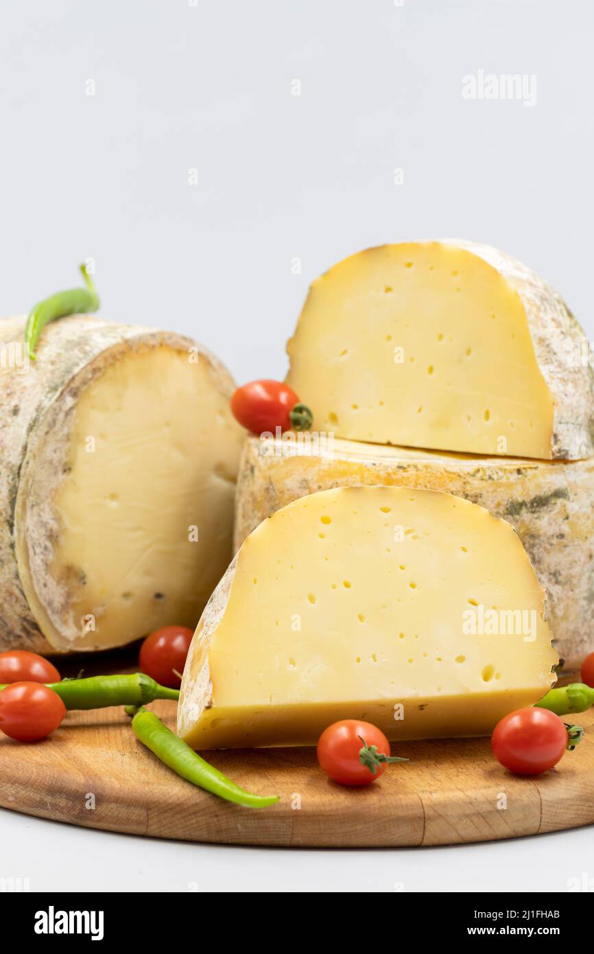 Goat cheddar cheese isolated on a white background. close up Stock ...