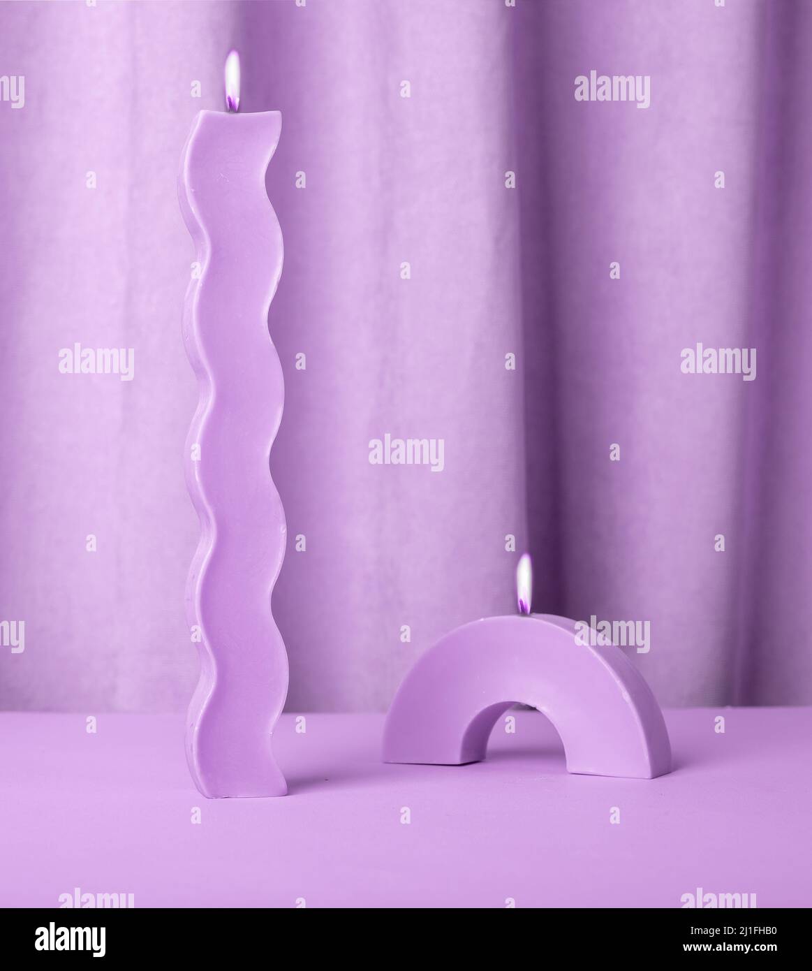 Purple modern candles of wave and arch shapes on violet background ...