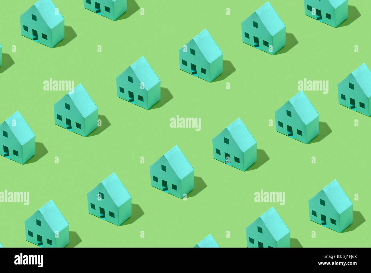 Diagonal rows of little green model houses arranged as a repeat pattern ...