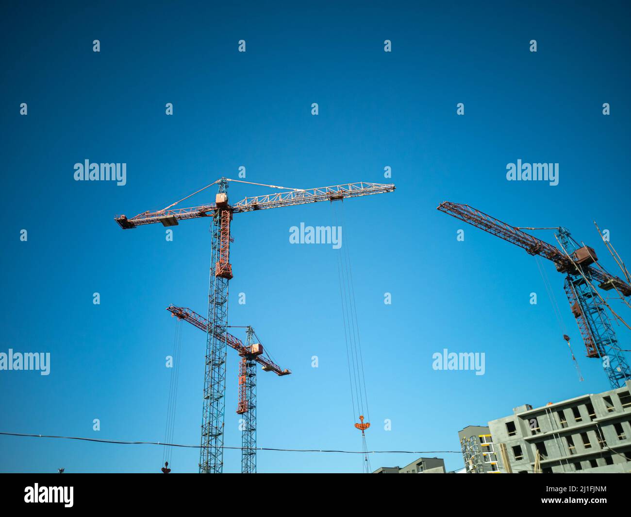Tower cranes at the construction site. Construction of panel high-rise ...