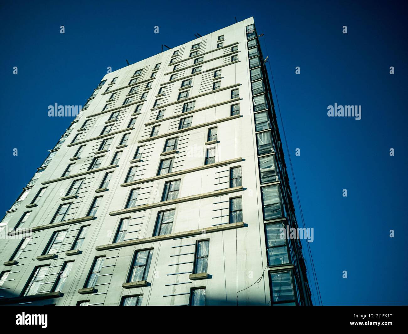 An unfinished apartment building against the sky. Construction of panel ...