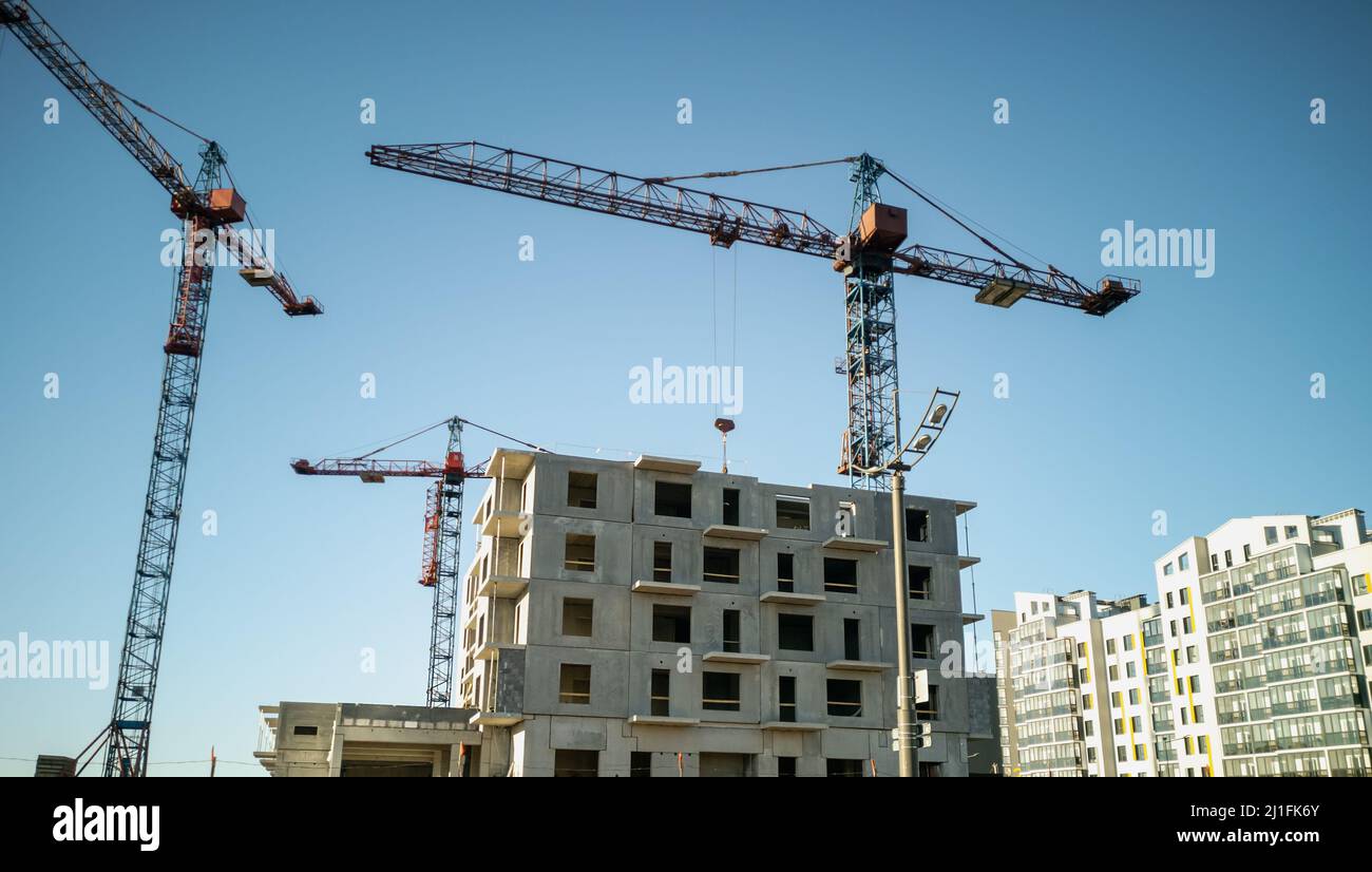 Tower cranes at the construction site. Construction of panel high-rise ...