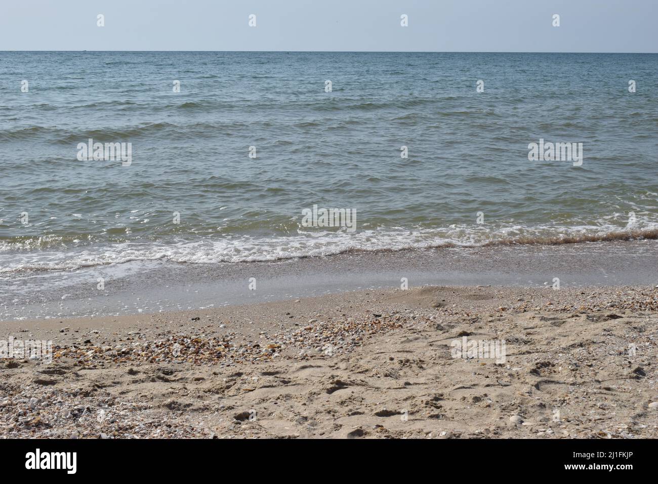 Beautiful landscape - turquoise colored sea water, sand, sky. The waves ...
