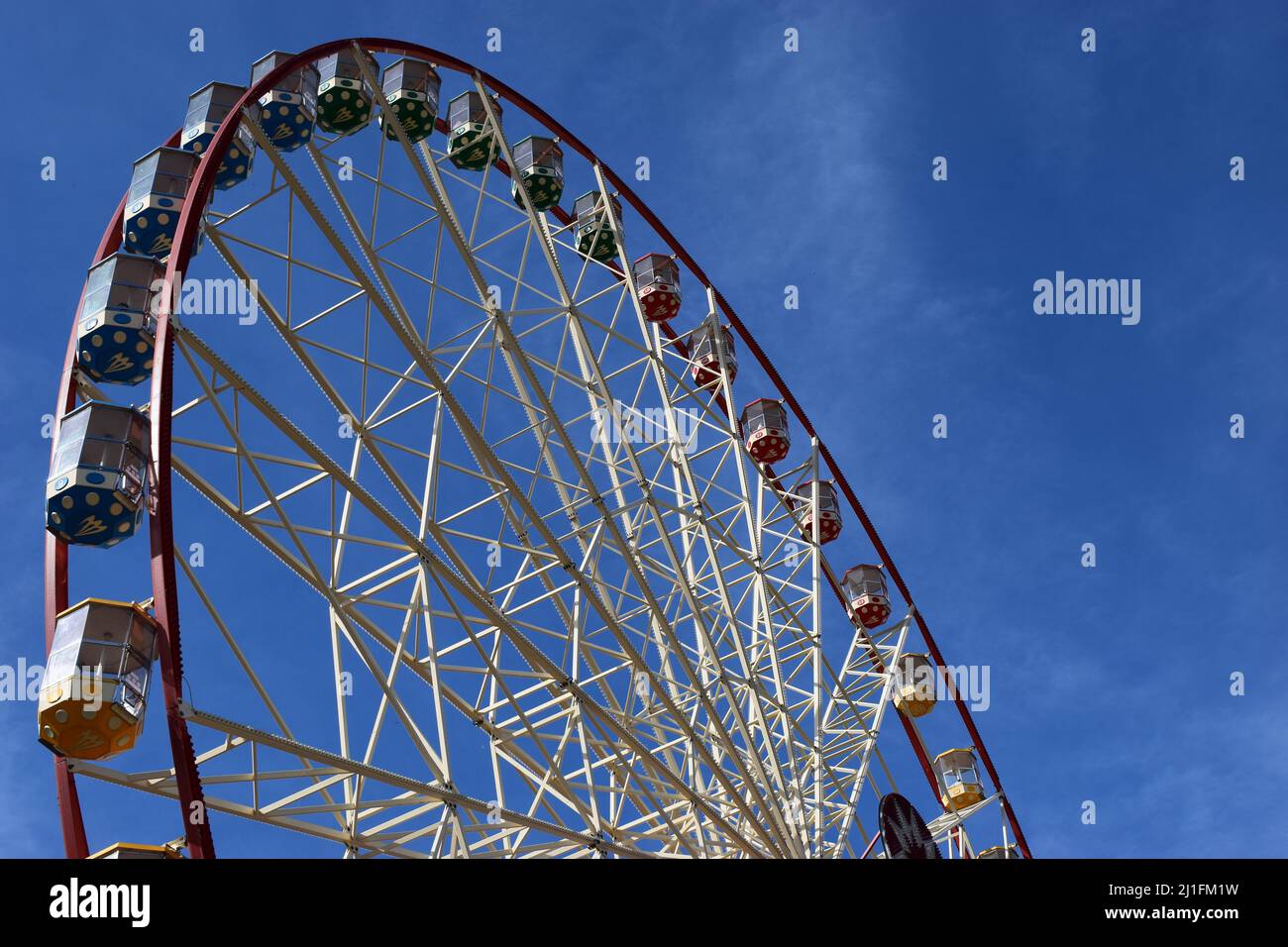 Ferris wheel against the blue sky in the city park with copy space ...
