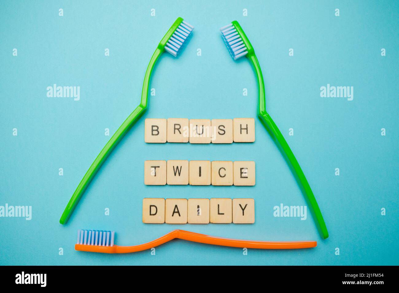 Oral and dental health concept showing three toothbrushes with a sign ...