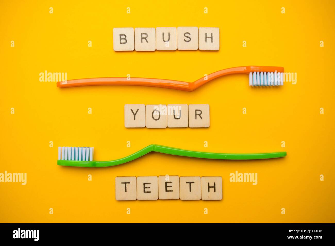 Oral and dental health concept showing two toothbrushes and a sign ...