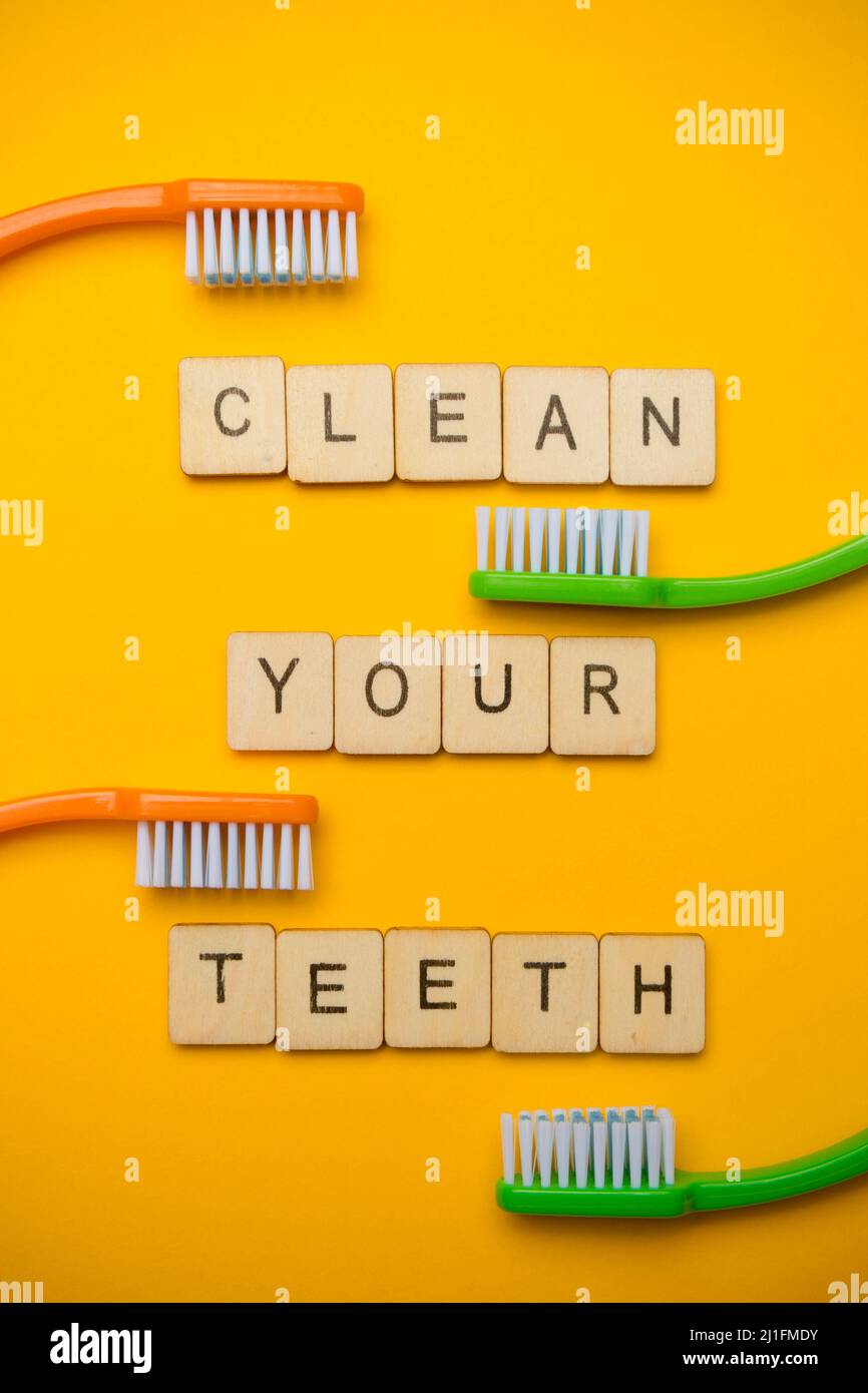 Oral and dental health concept showing four toothbrushes and a sign ...