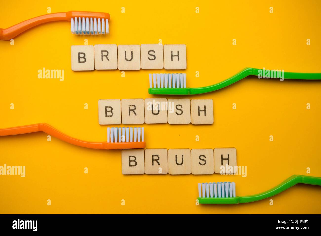 Oral and dental health concept showing four toothbrushes and a sign ...