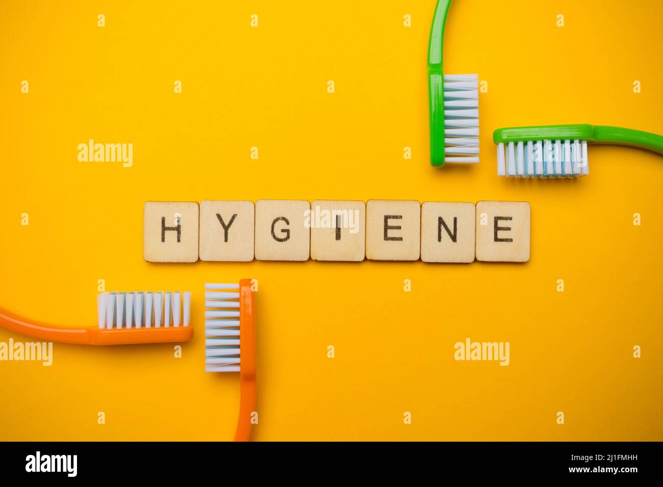 Oral and dental health concept showing four toothbrushes and a sign ...