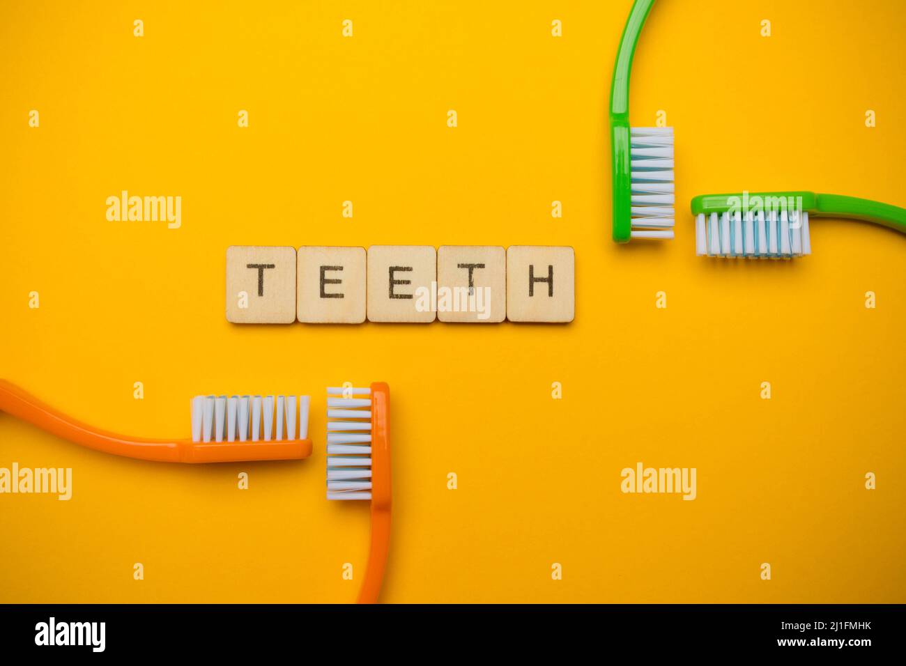 Oral and dental health concept showing four toothbrushes and a sign ...