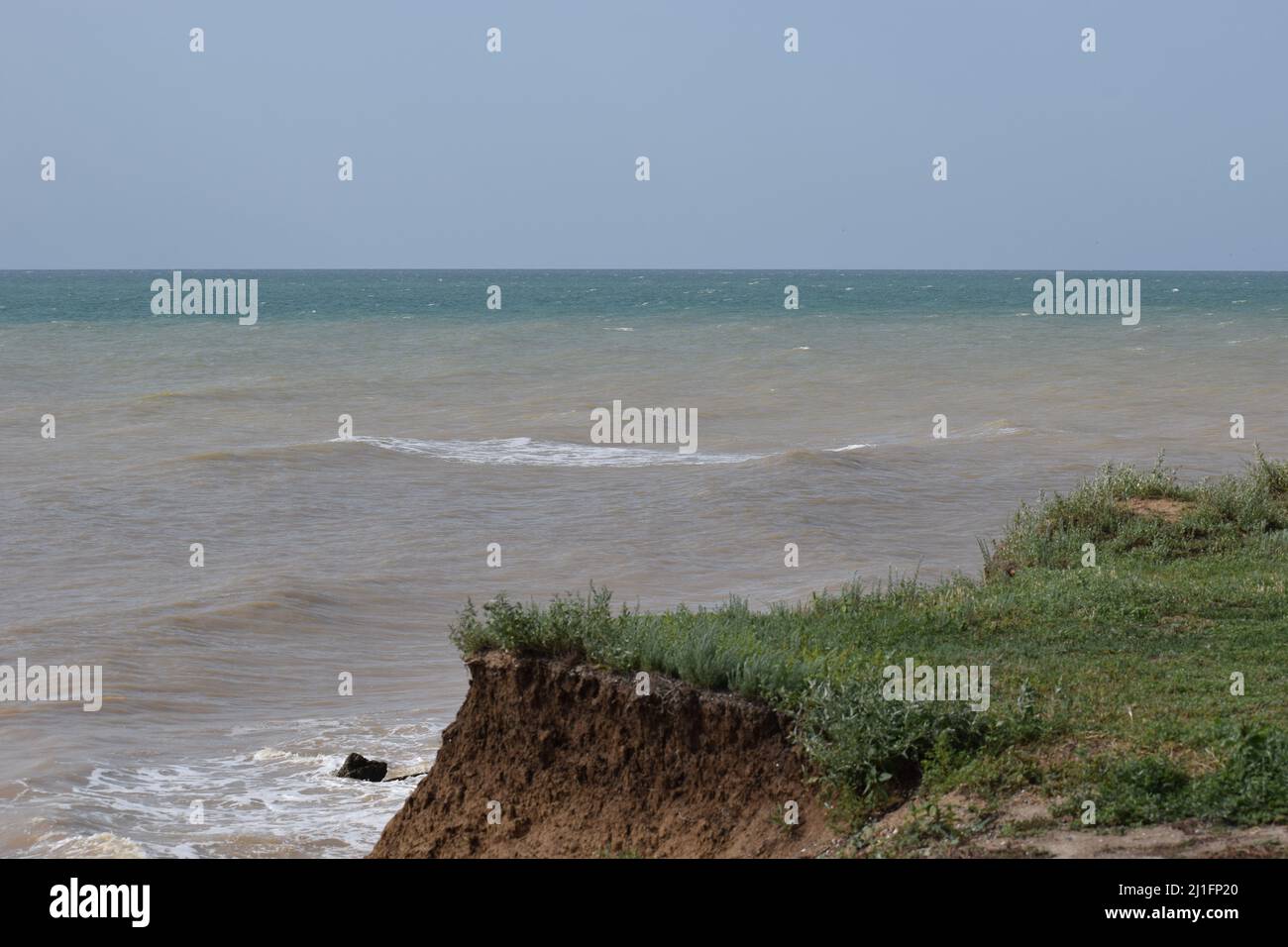 Sea cliffs of boulder clay in front of beaches. Clay Cliffs and Beach with Blue Sky and Water ...