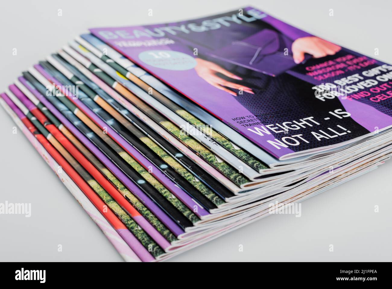 pile of beauty and style magazines on grey background, close up view ...