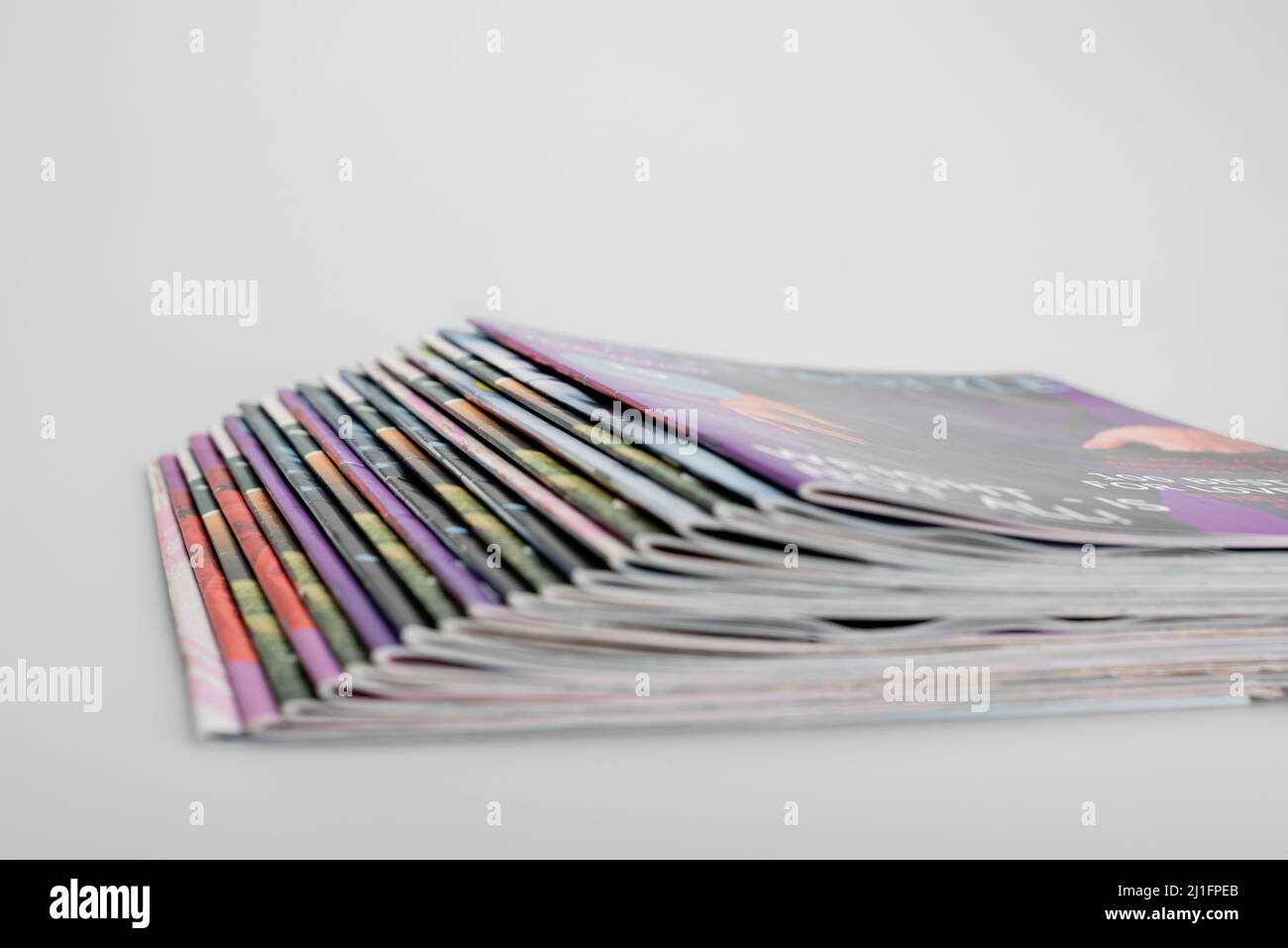 stack of blurred magazines on grey background Stock Photo - Alamy