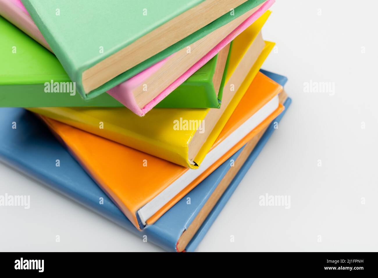 stack of books with multicolored covers on grey background Stock Photo ...