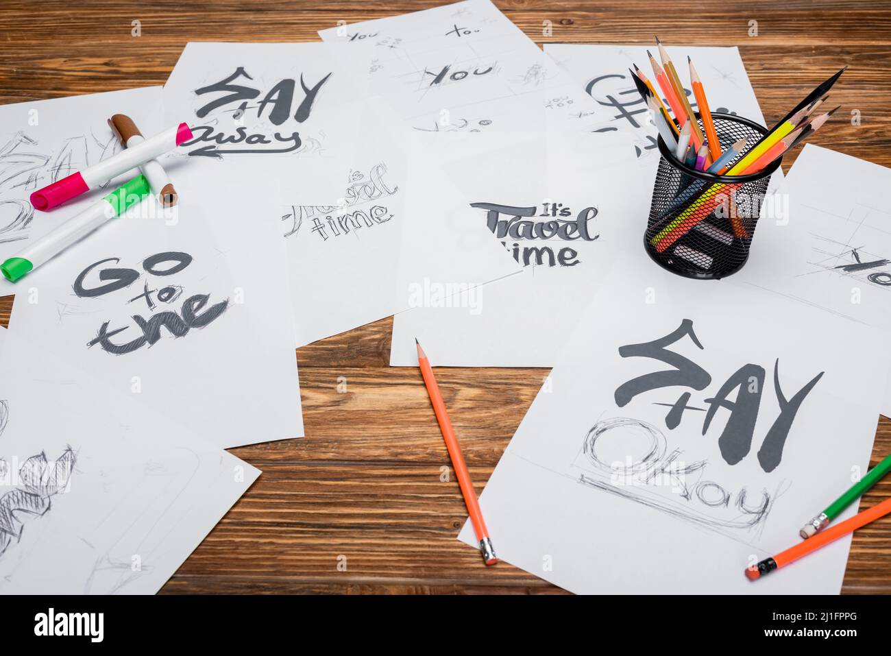 papers with different words and phrases, felt pens and color pencils on ...